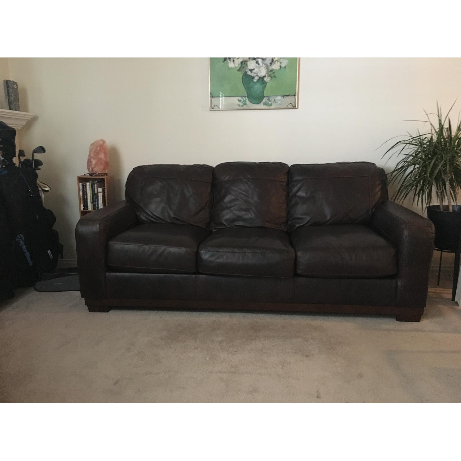 Ashley's Crestwood Walnut Leather Sofa - AptDeco