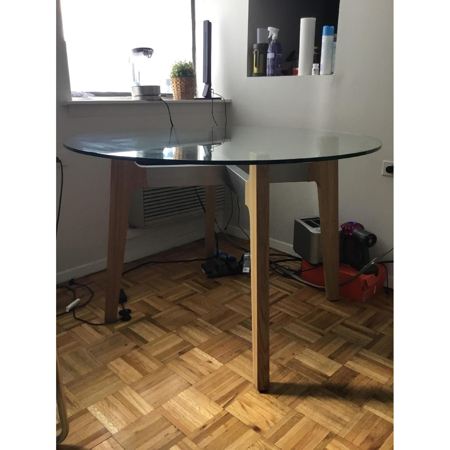 CB2 Round Dining Table w/ Glass Top - AptDeco