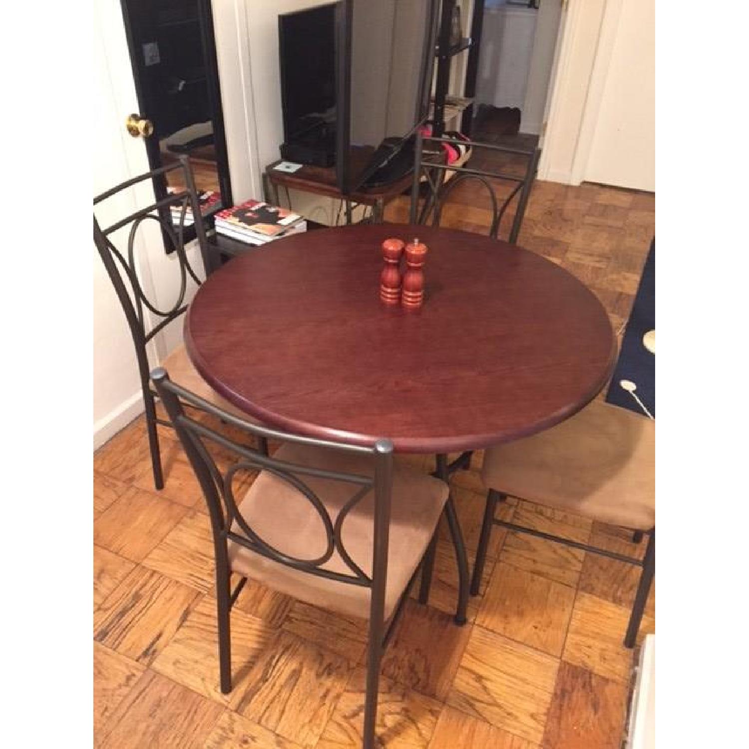 Ikea Dark Wood Round Table w/ 4 Iron Chairs - AptDeco