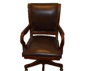 Haverty's Ergonomic Swivel Adjustable Leather/Wood Office Chair - AptDeco