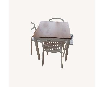 IKEA Square wooden table with 4 matching metal chairs - AptDeco
