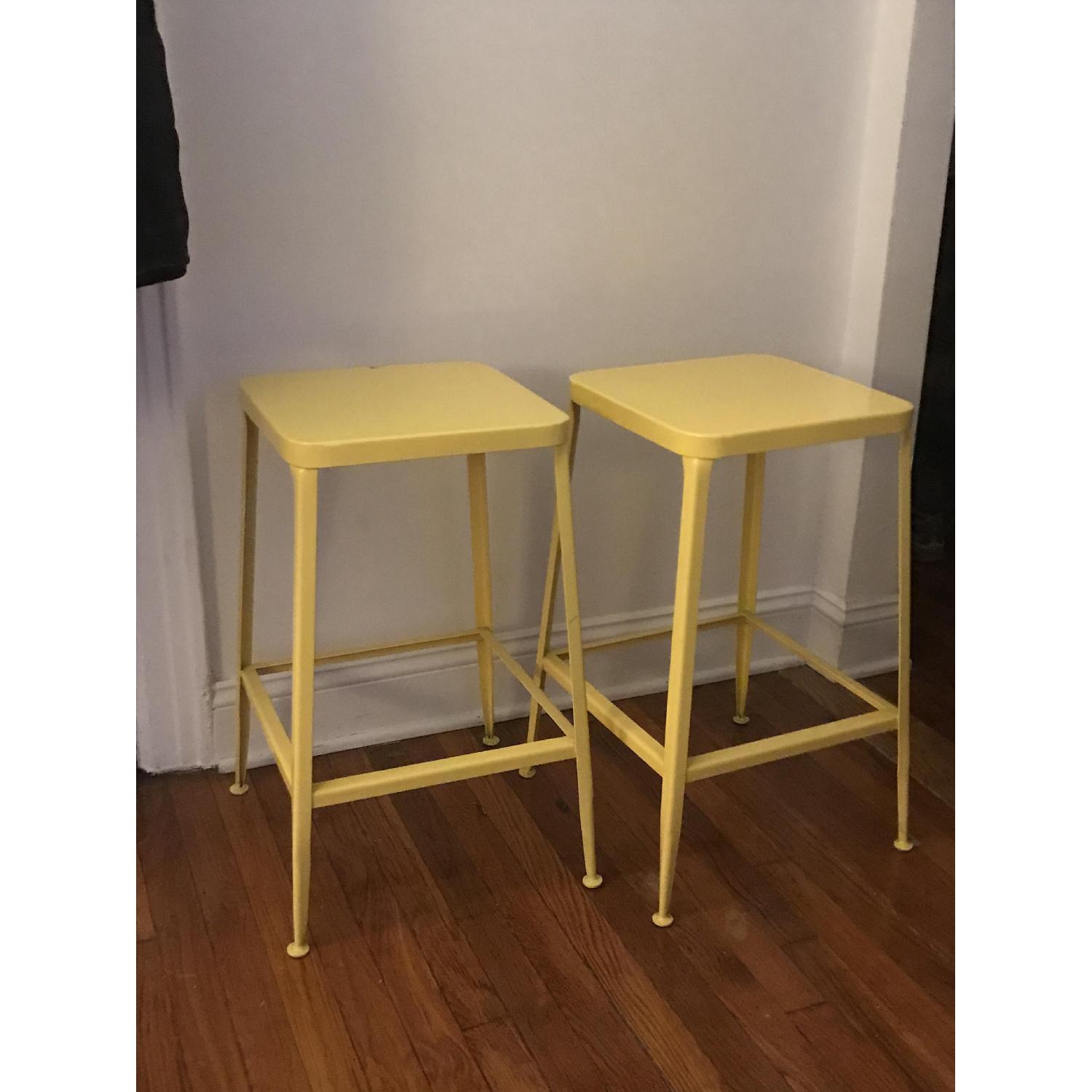 CB2 Steel Bar Stools in Yellow - AptDeco