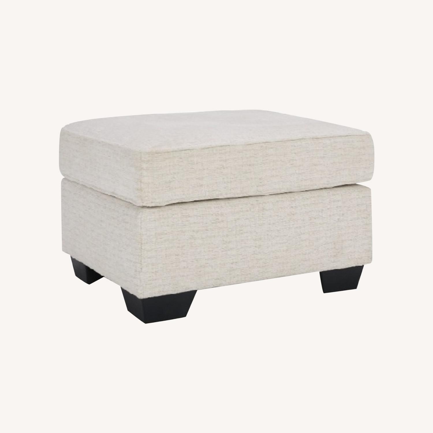 Ashley Cashton White Ottoman - AptDeco