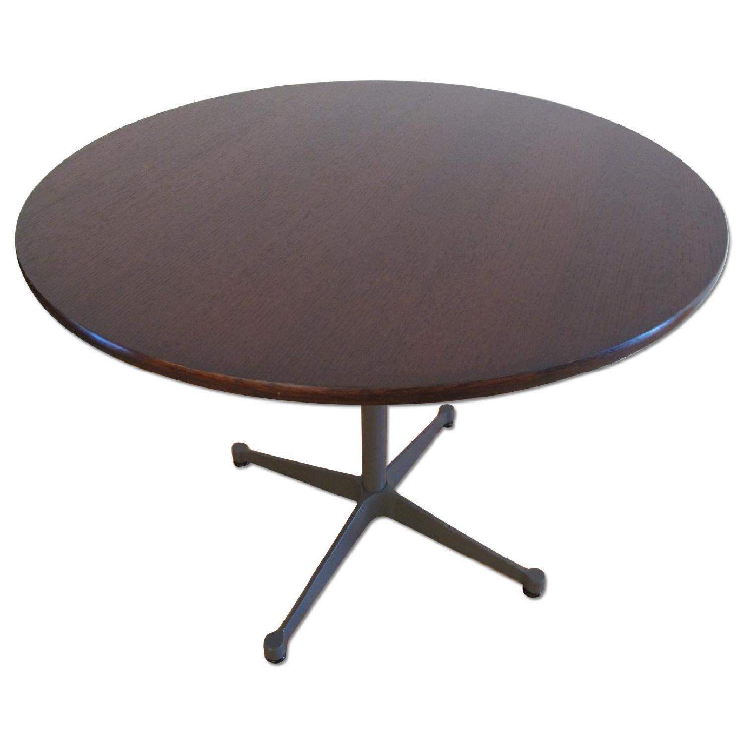 Herman Miller Round Dark Wood Dining Table - AptDeco